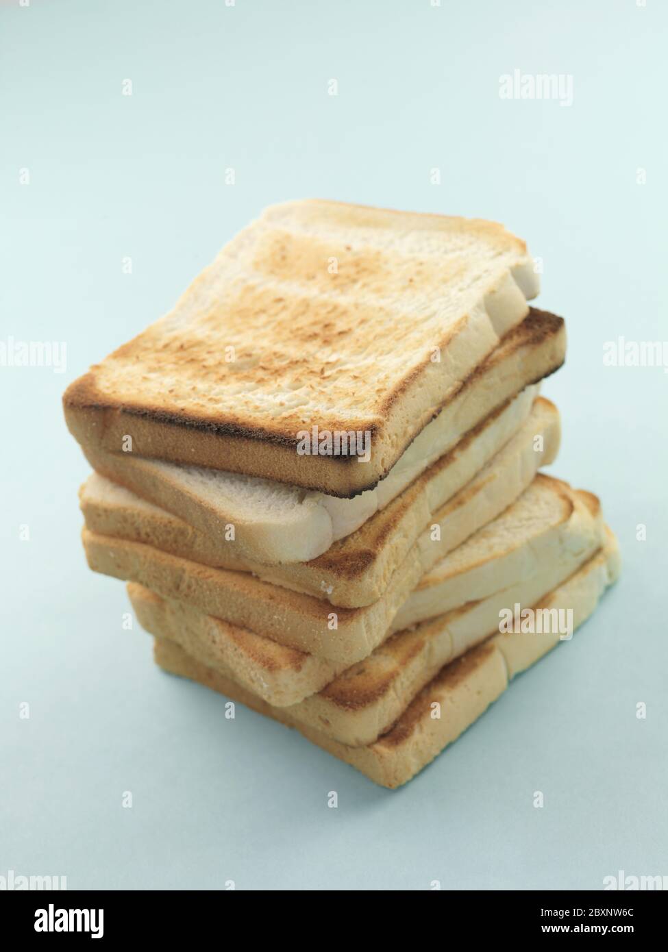 Plain white toast isolated against a pale blue background Stock Photo ...