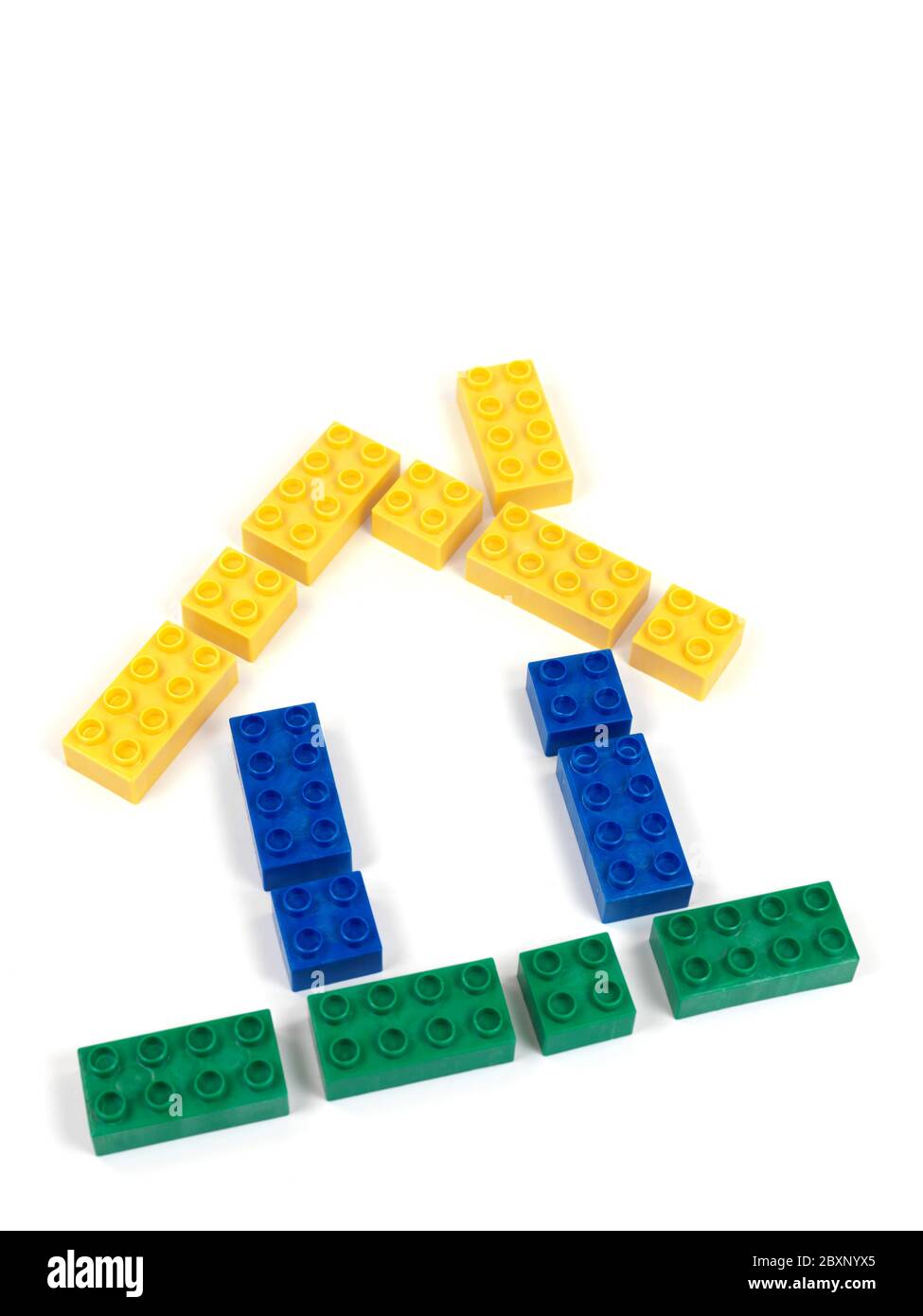 A toy house made from toy blocks isolated against a white background ...