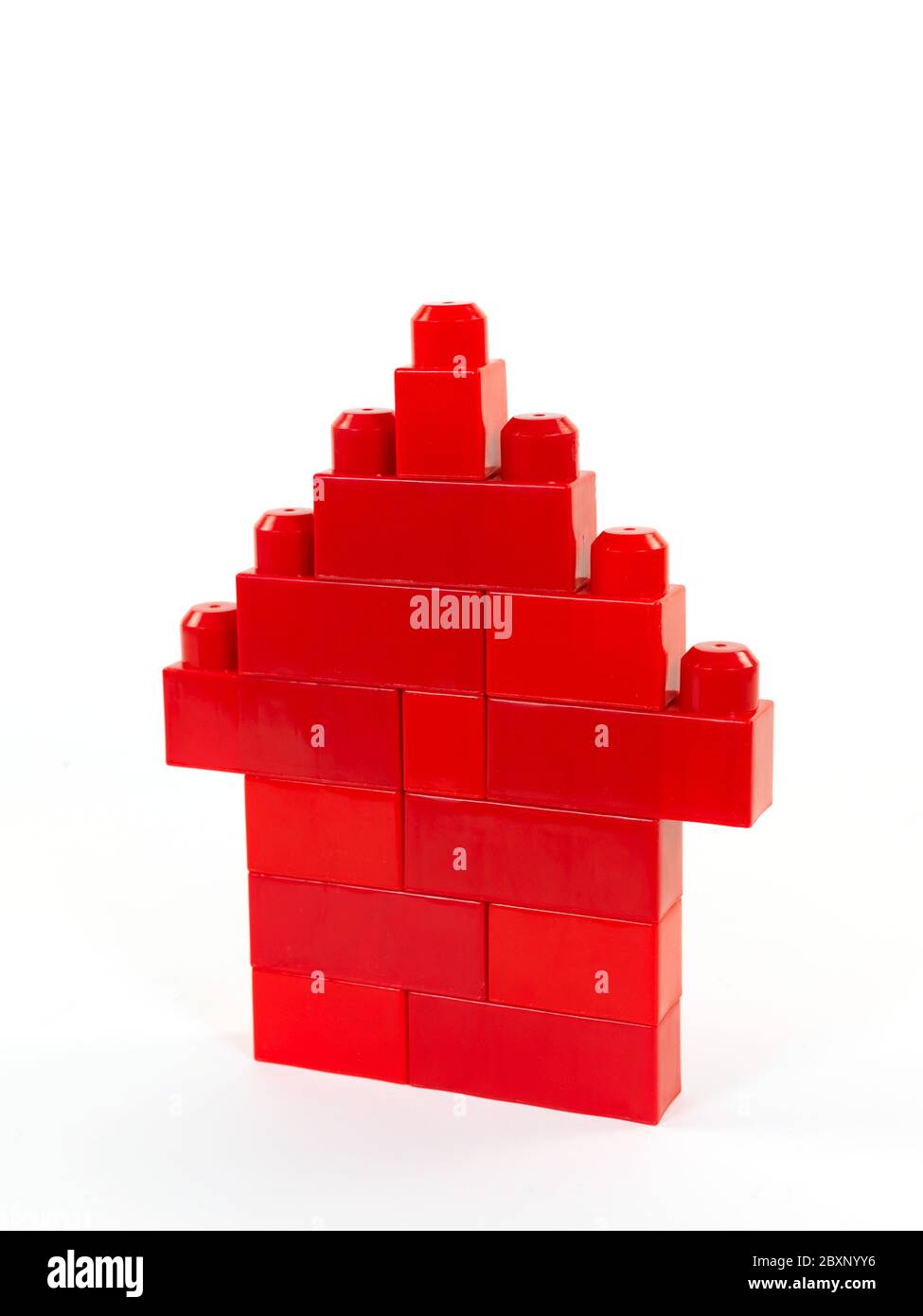 A toy house made from building blocks isolated against a white ...