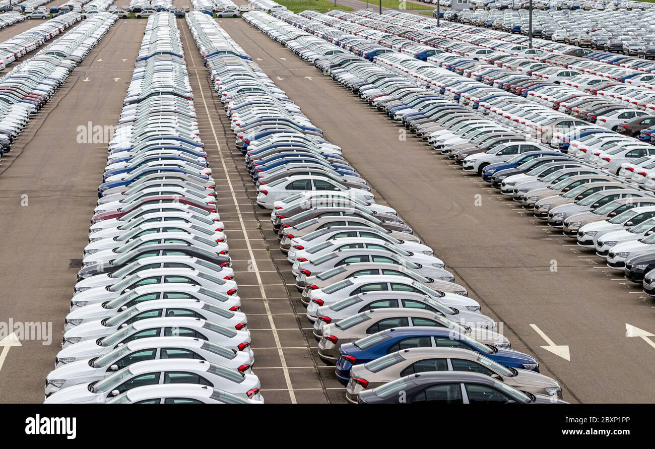 Rows of a new cars parked in a distribution center on a cloudy day in ...