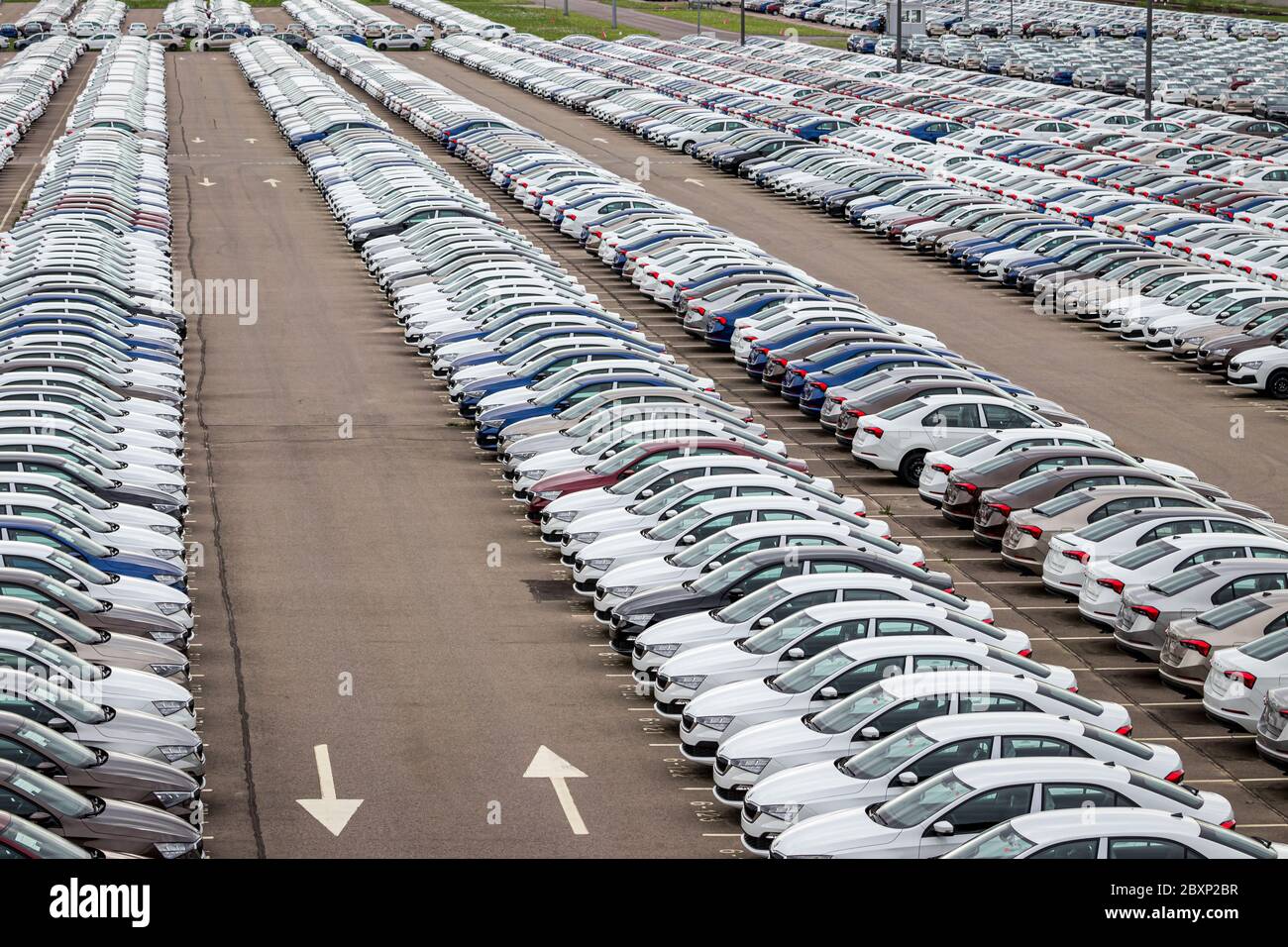 Rows of a new cars parked in a distribution center of a car factory ...