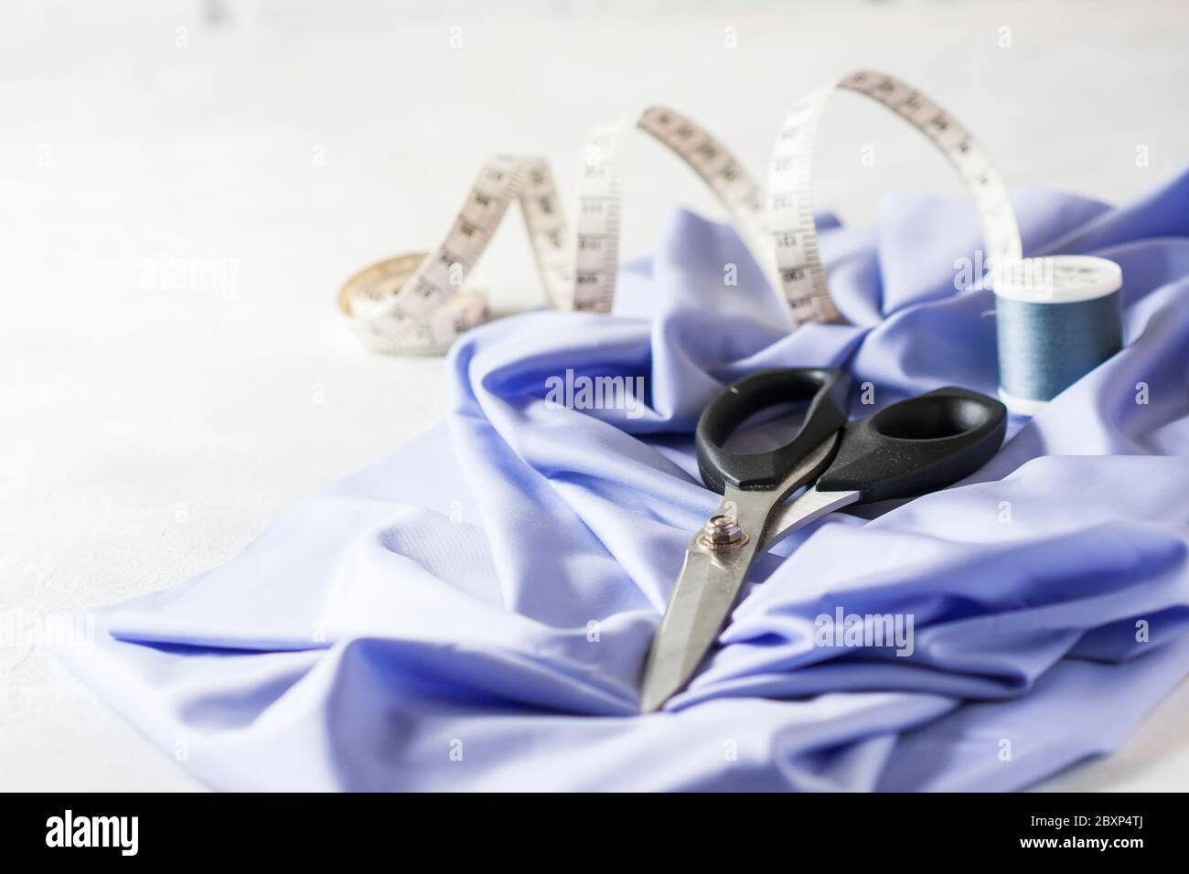 Everything for sewing. Beige fabric, sewing accessories and scissors ...