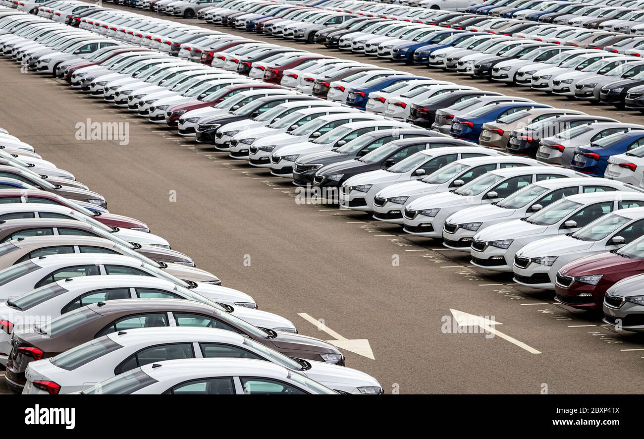 Rows of a new cars parked in a distribution center of a car factory ...