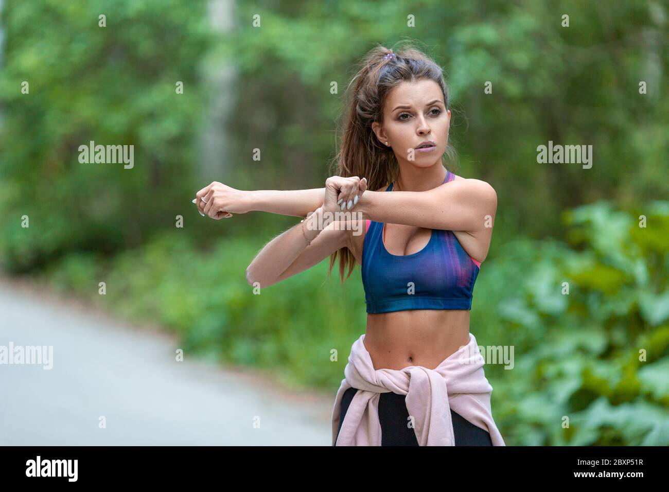 Sport and healthy lifestyle concept - woman warming muscles before ...