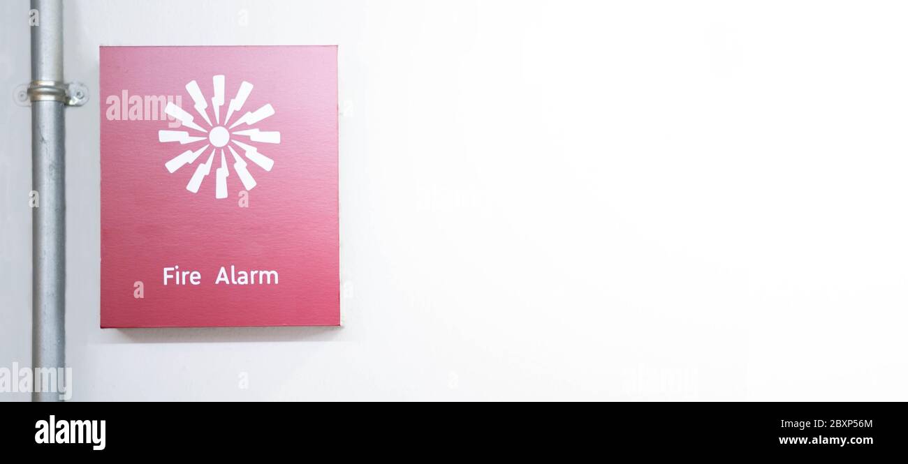 Red fire alarm sign symbol is on the white wall, Every building is ...