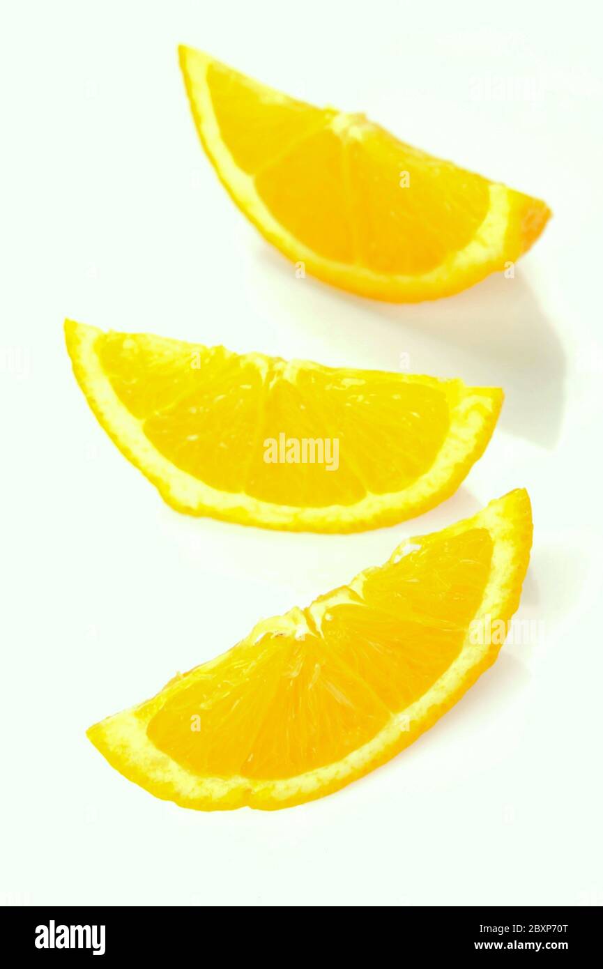 Orange quarters isolated against a white background Stock Photo - Alamy