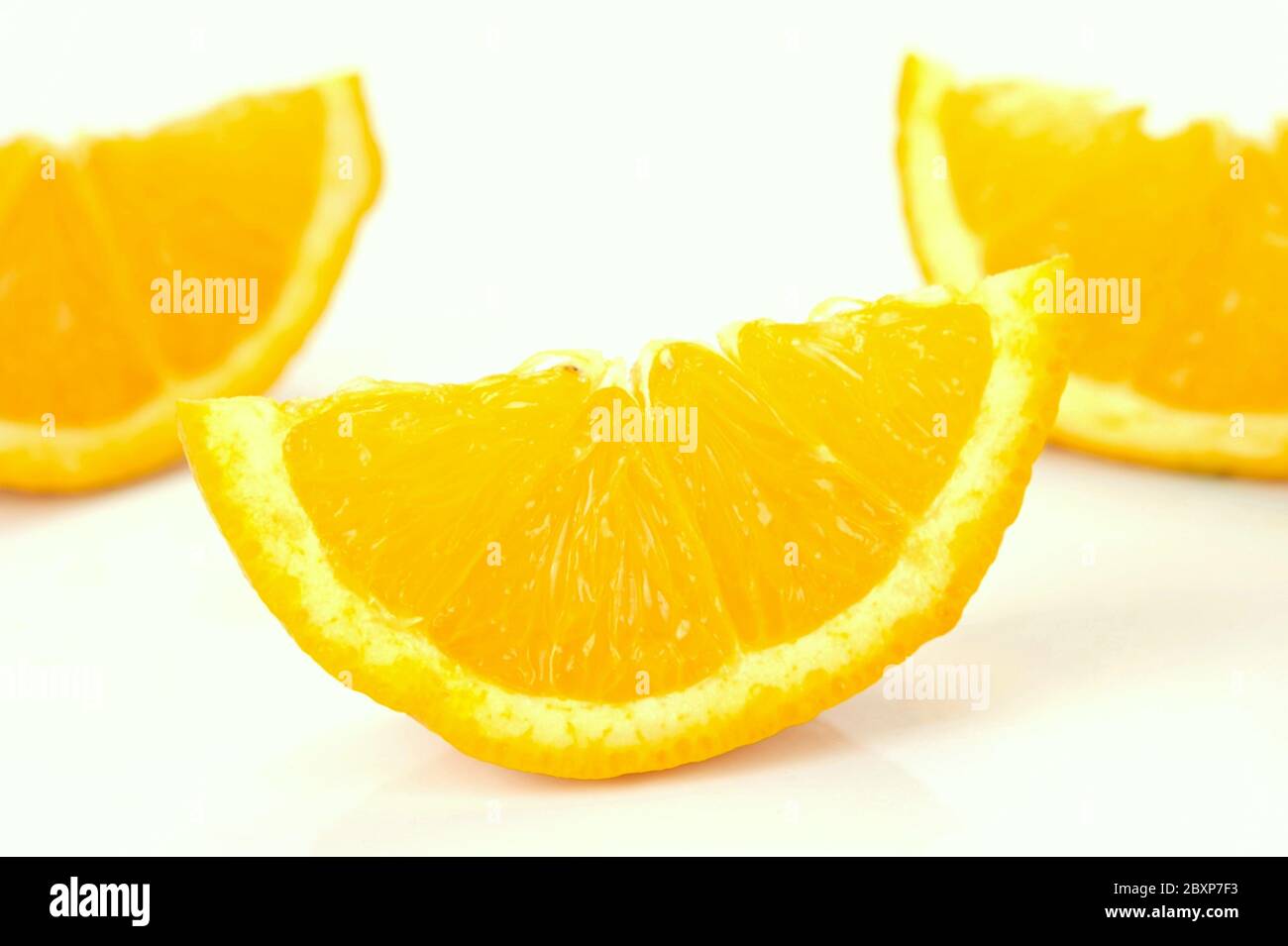 Orange quarters isolated against a white background Stock Photo - Alamy