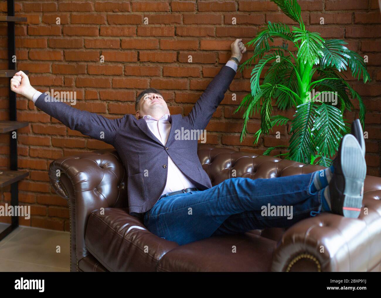 Businessman having rest after strong, but successful negotiations and ...