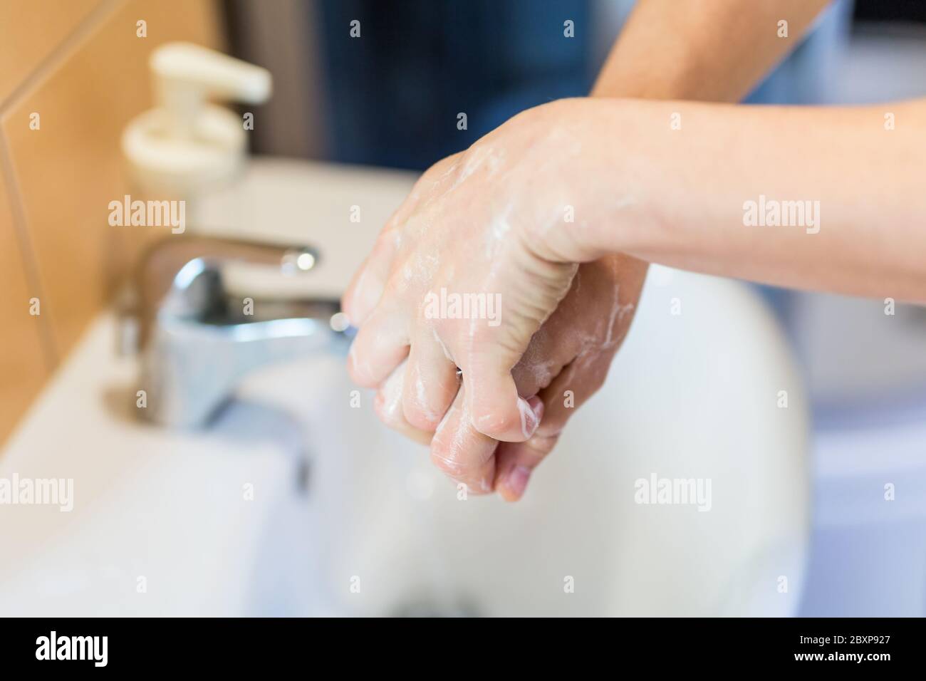 Washing hands with soap under the faucet with water . Hygiene concept ...