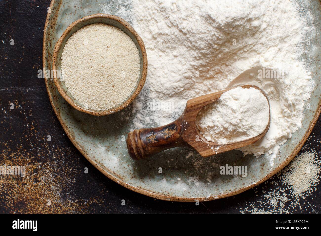 Raw fonio flour and seeds with a spoon on dark background ещз мшуц ...