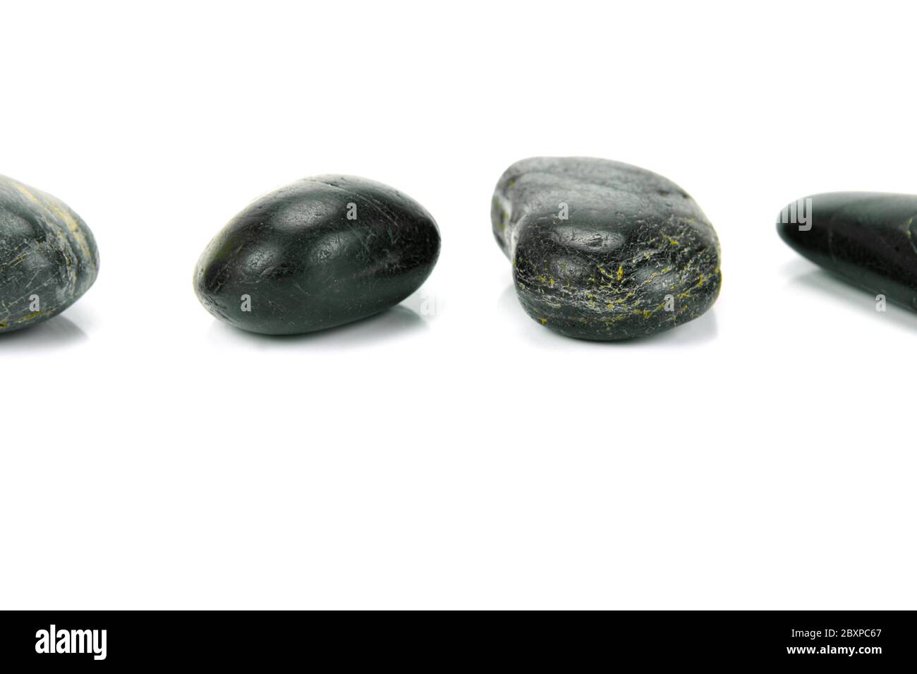 Black river rocks isolated against a white background Stock Photo - Alamy