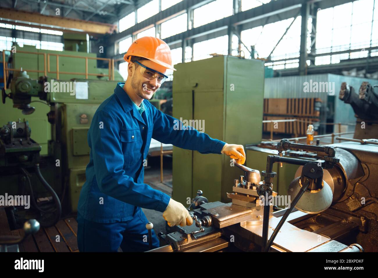 Worker turning on industrial machine hi-res stock photography and ...