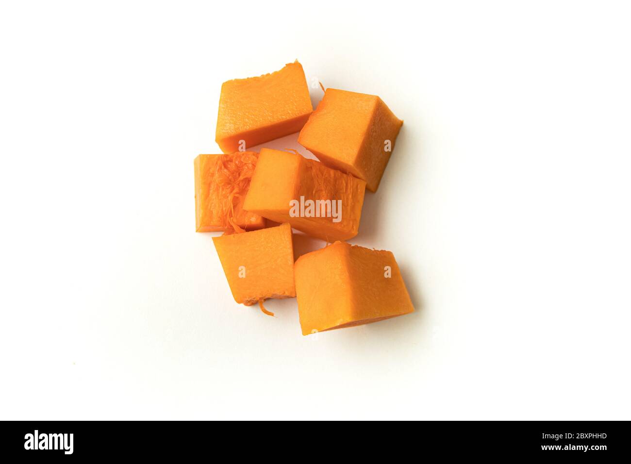 Pumpkin cut into cubes isolated on white background Stock Photo - Alamy