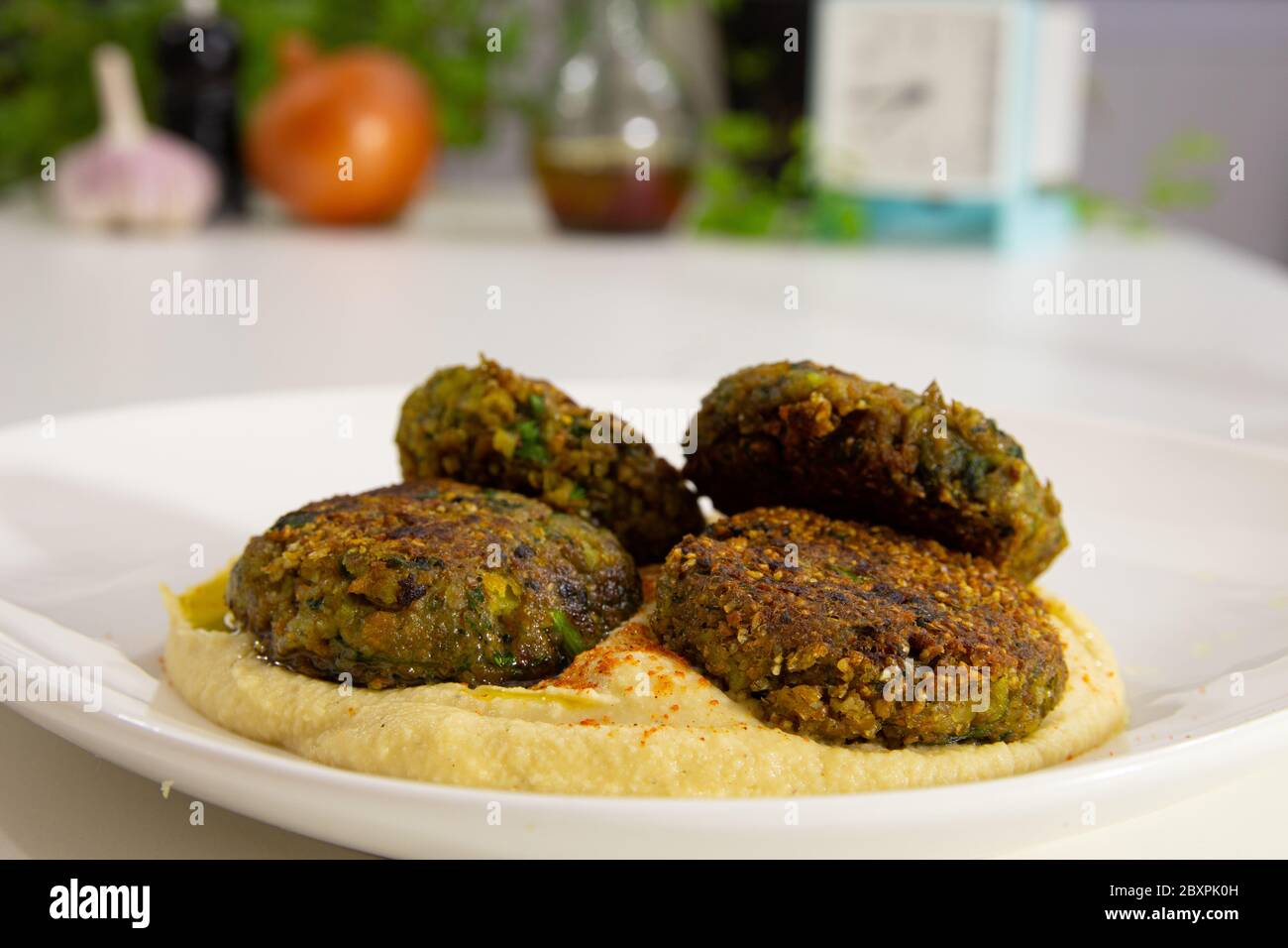 Lentil Kibbeh with chickpeas hummus over a white table Stock Photo - Alamy