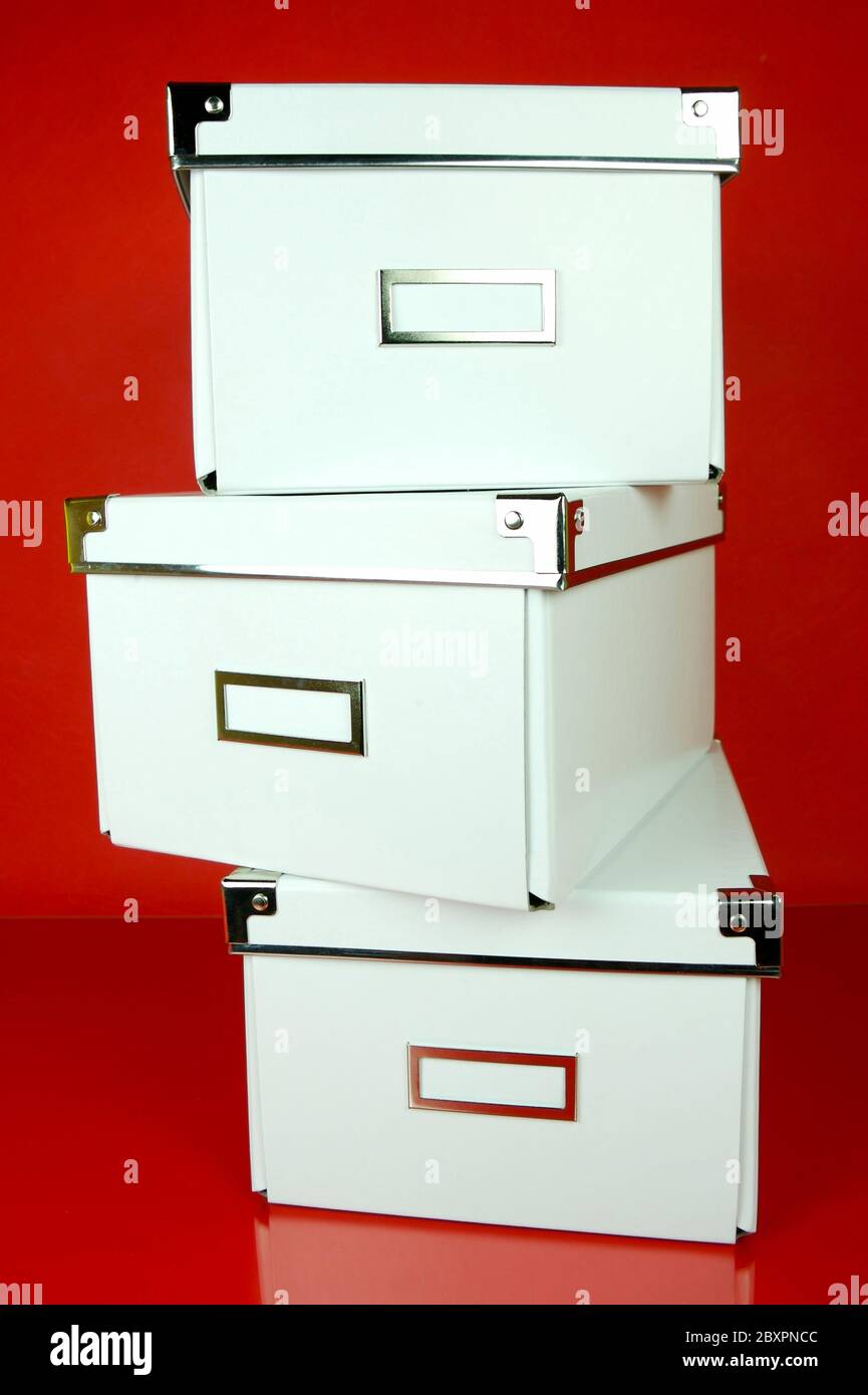 Storage boxes isolated against a red background Stock Photo - Alamy
