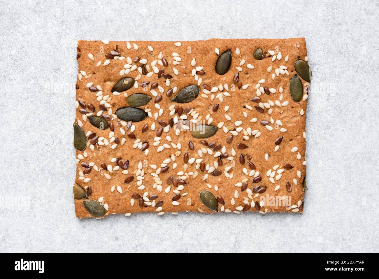 Whole grain rye crispbread cracker isolated on grey concrete background ...