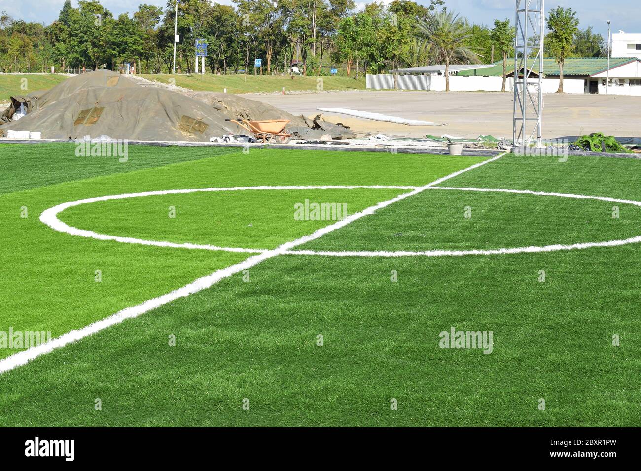 Between the dividing line of the football field, artificial grass and ...
