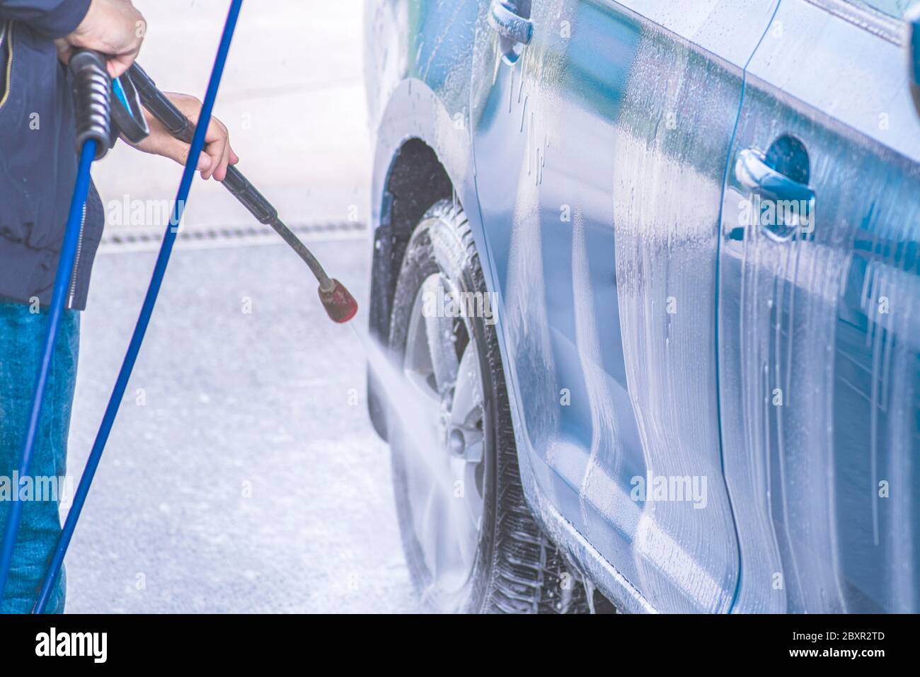 A Man Washes A Car On His Own Car Wash Self Service Cheap Car Wash