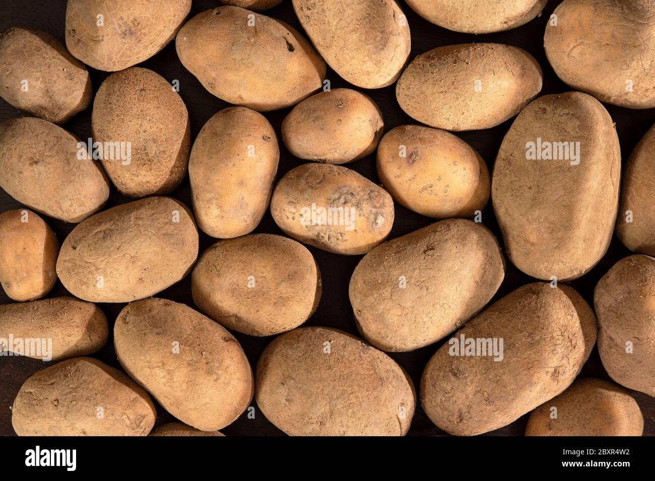 Raw potato texture in rustic style Stock Photo - Alamy