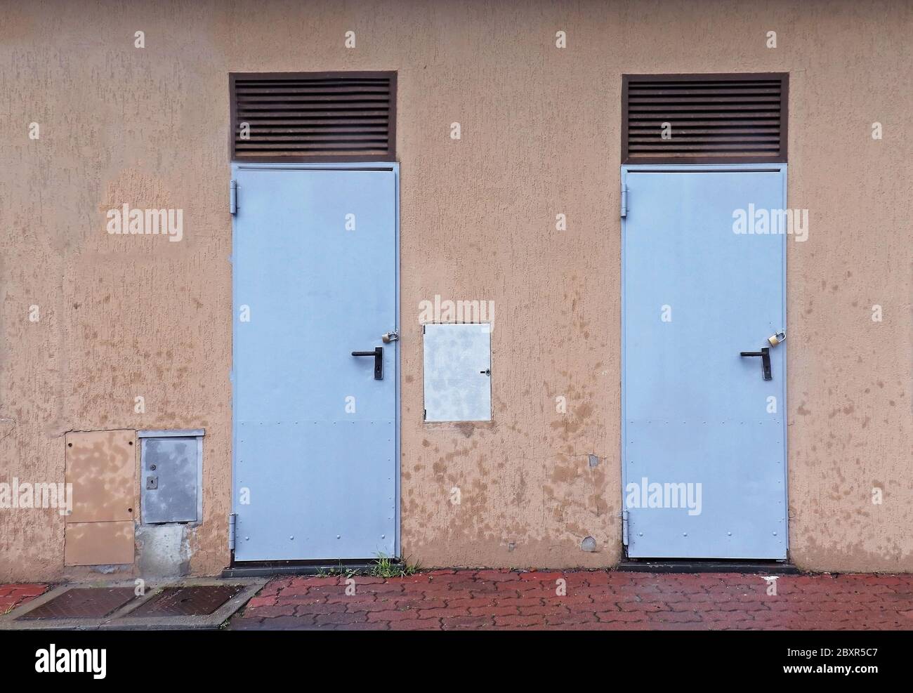 Two metal doors with dirty building facade closed from outside Stock ...