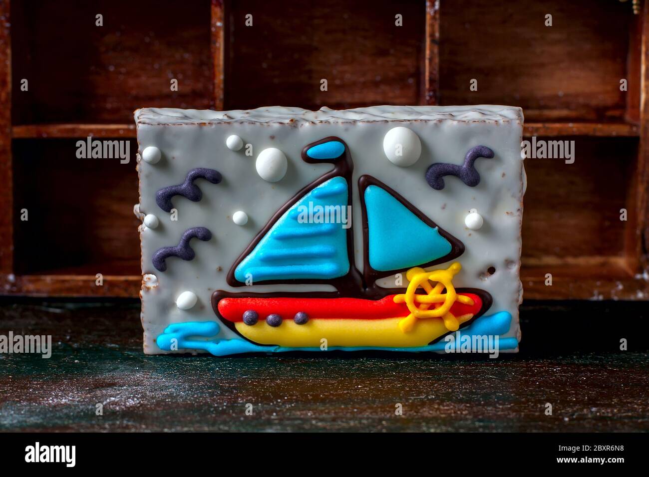 Homemade homemade gingerbread cookie in the shape of a boat on the dark ...
