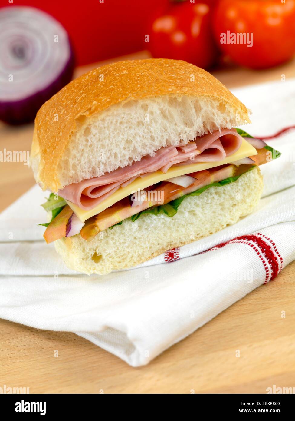 A ham and salad roll on a kitchen bench Stock Photo - Alamy