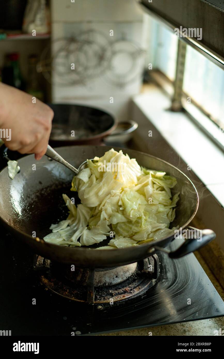 A chef is cooking cabbage Stock Photo - Alamy