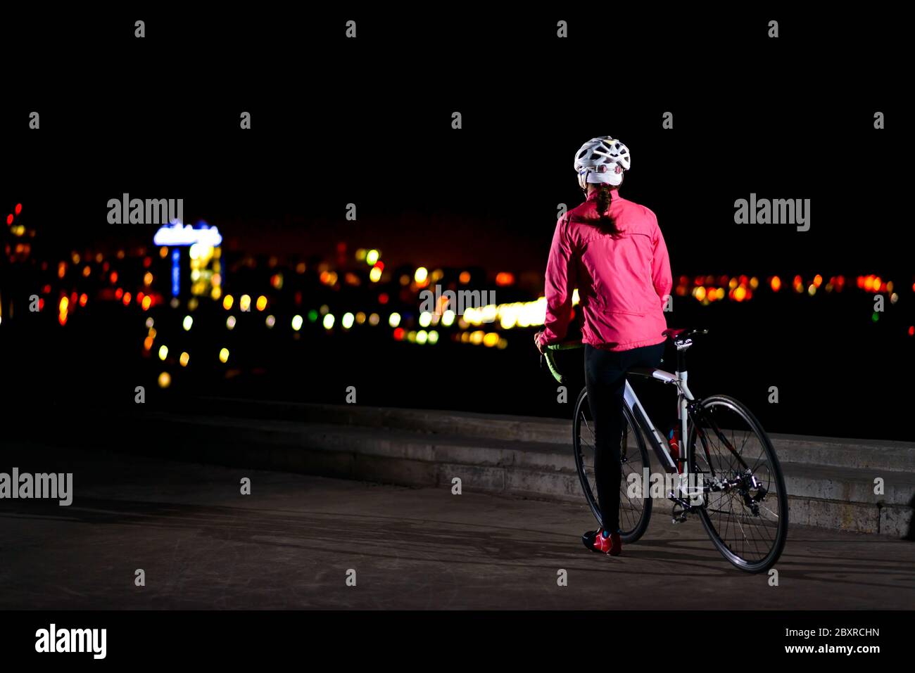Young Woman Cyclist Resting with Road Bike and Looking at Night City ...