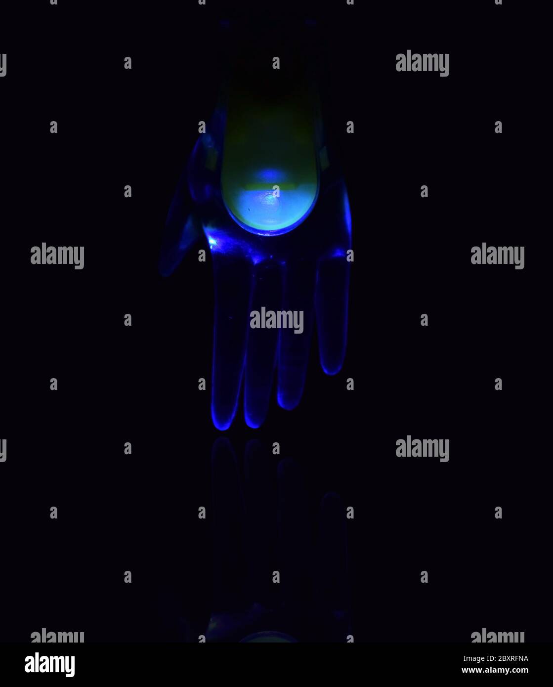 Blue glowing hand, light effect in darkness Stock Photo - Alamy