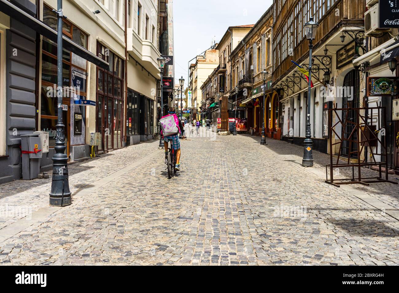 A Food Panda food delivery courier on a bike in Old Town of Bucharest ...