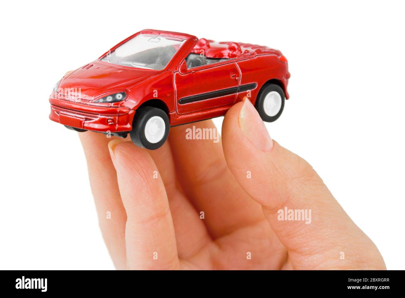 Hand and toy car Stock Photo - Alamy