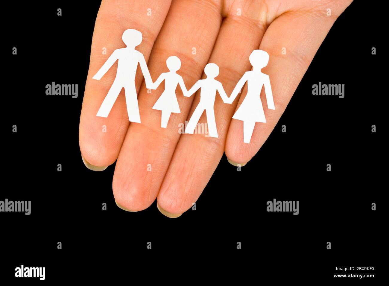 Paper family in hand Stock Photo - Alamy
