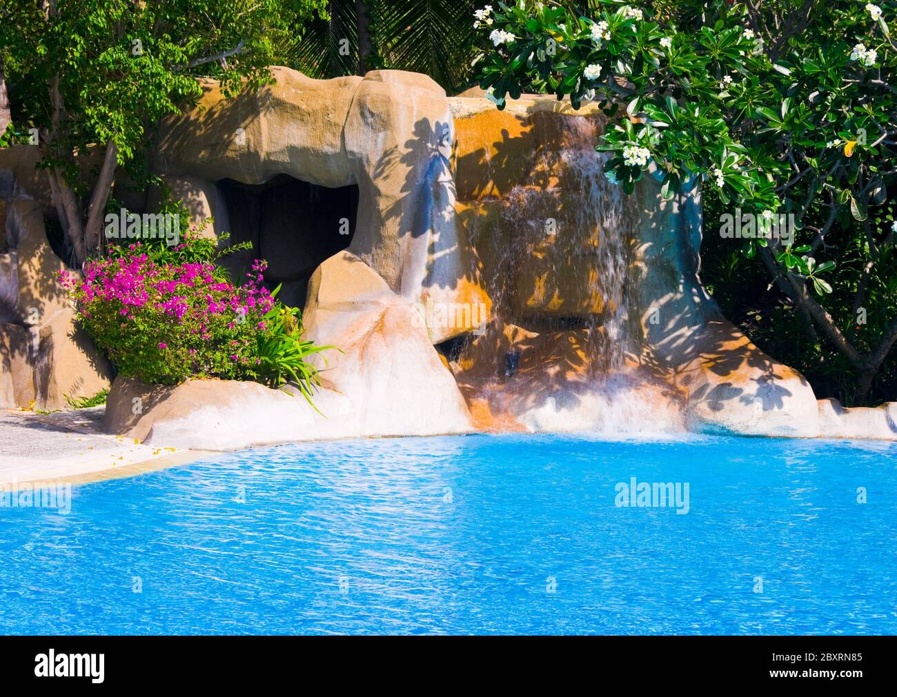 Pool and waterfall in hotel Stock Photo - Alamy