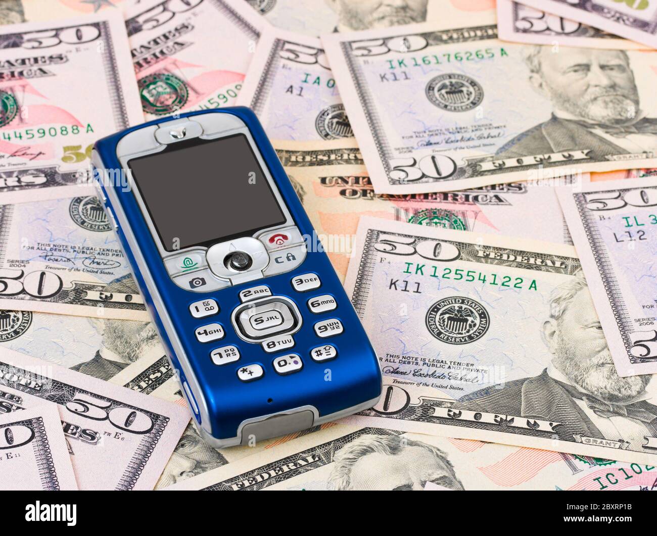 Mobile phone on money background Stock Photo - Alamy