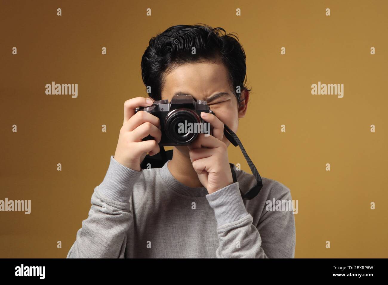 Happy Asian boy doing photography leisure activity, kid as photographer ...