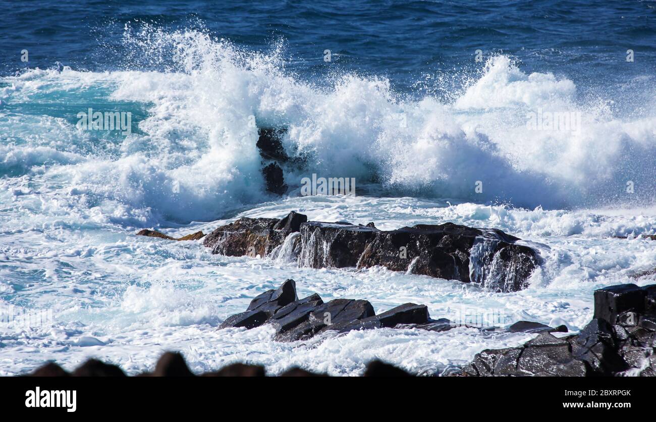 Ocean waves falling on the coast, water splash and droplets, Tenerife ...