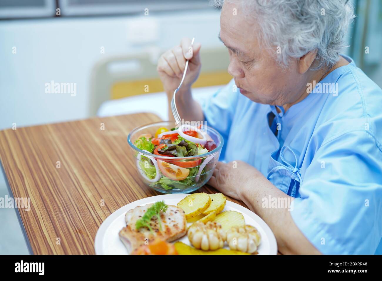 Asian senior or elderly old lady woman patient eating breakfast ...