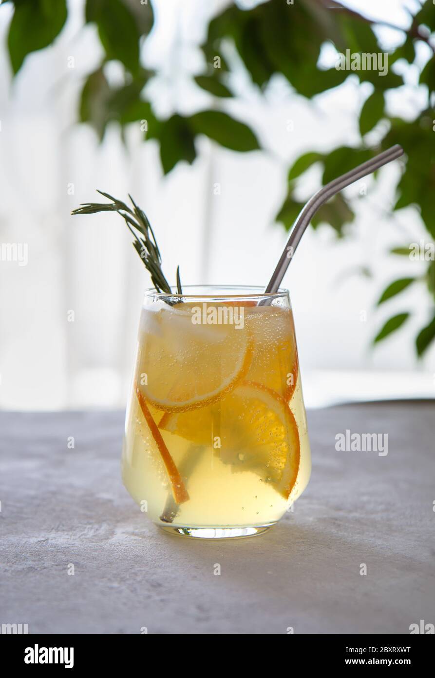 Lemonade with orange and ice on a window background Stock Photo - Alamy