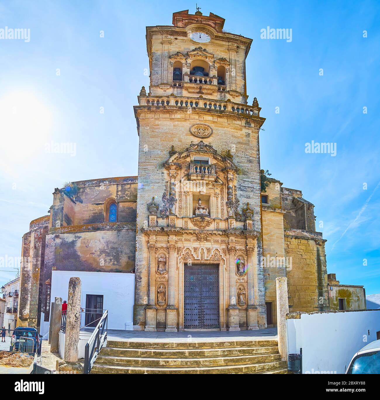 The tall bell tower of San Pedro church, decorated with clock, carved ...