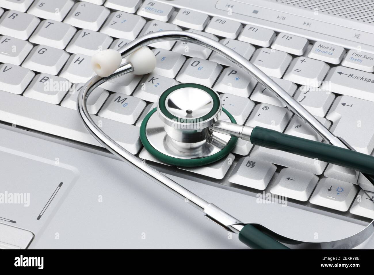 Medical stethoscope on a laptop signifying the relationship of IT and ...