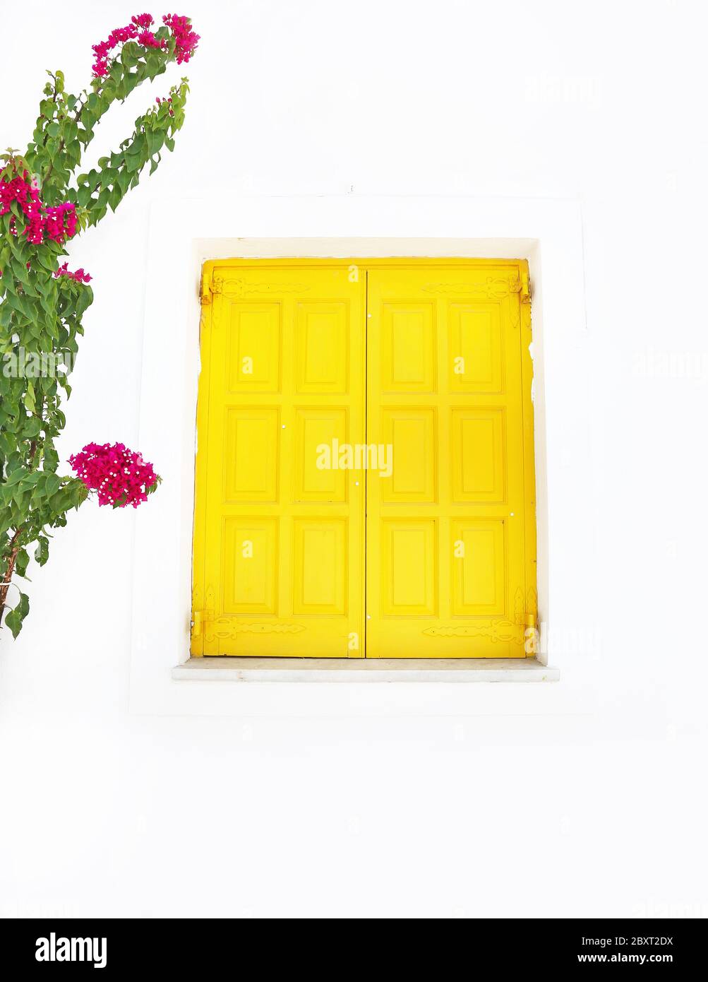traditional yellow window and bougainvillea flower at Ano Koufonisi ...