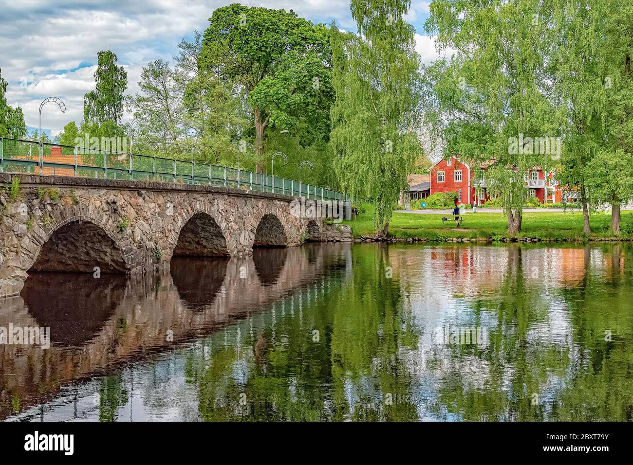 Broby stone bridge reflected on the water Stock Photo - Alamy