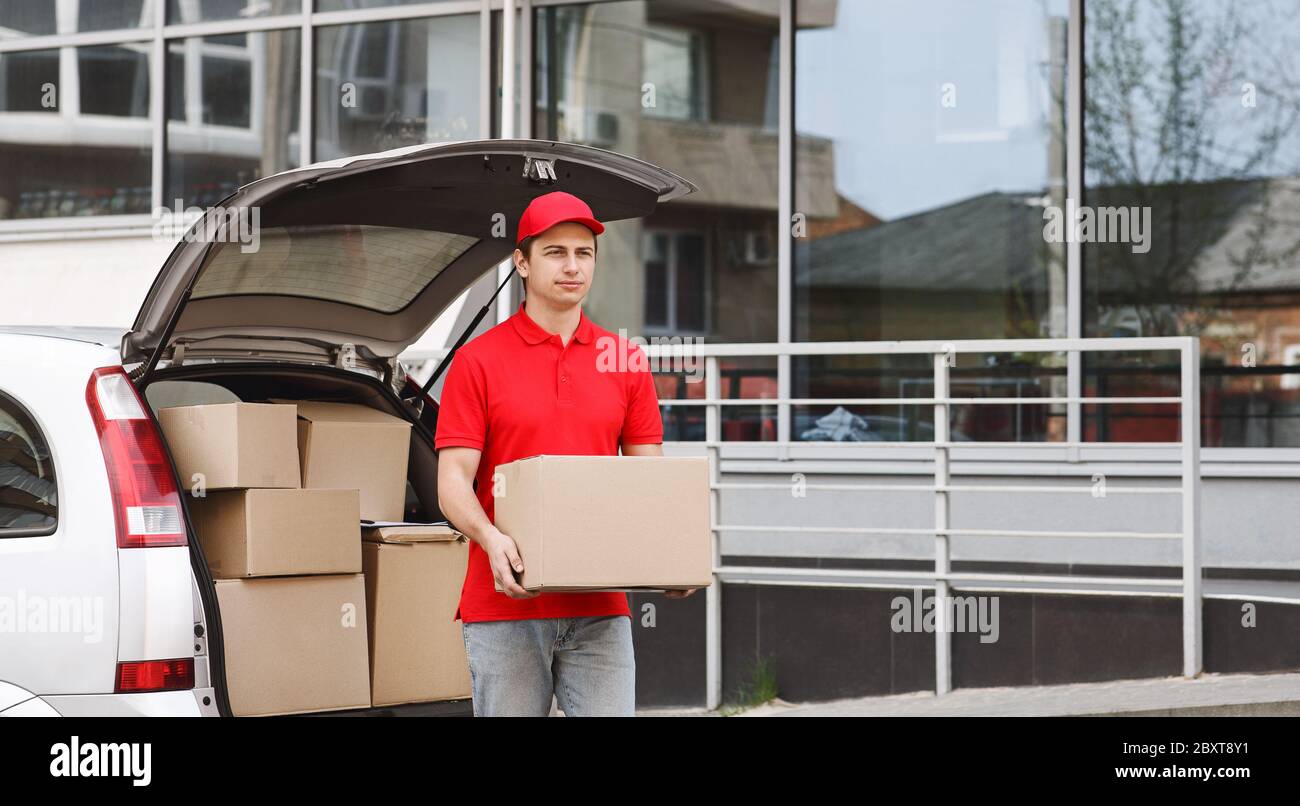 Transportation of box. Courier with parcel in hands goes to client home ...