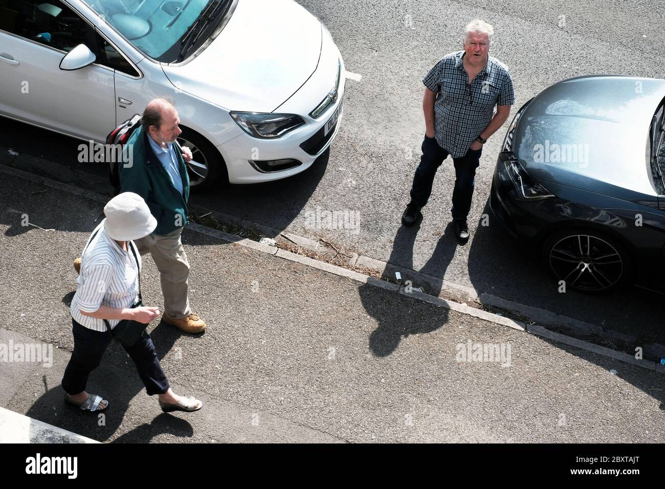 Friends talking through the window keeping a social distance during the ...
