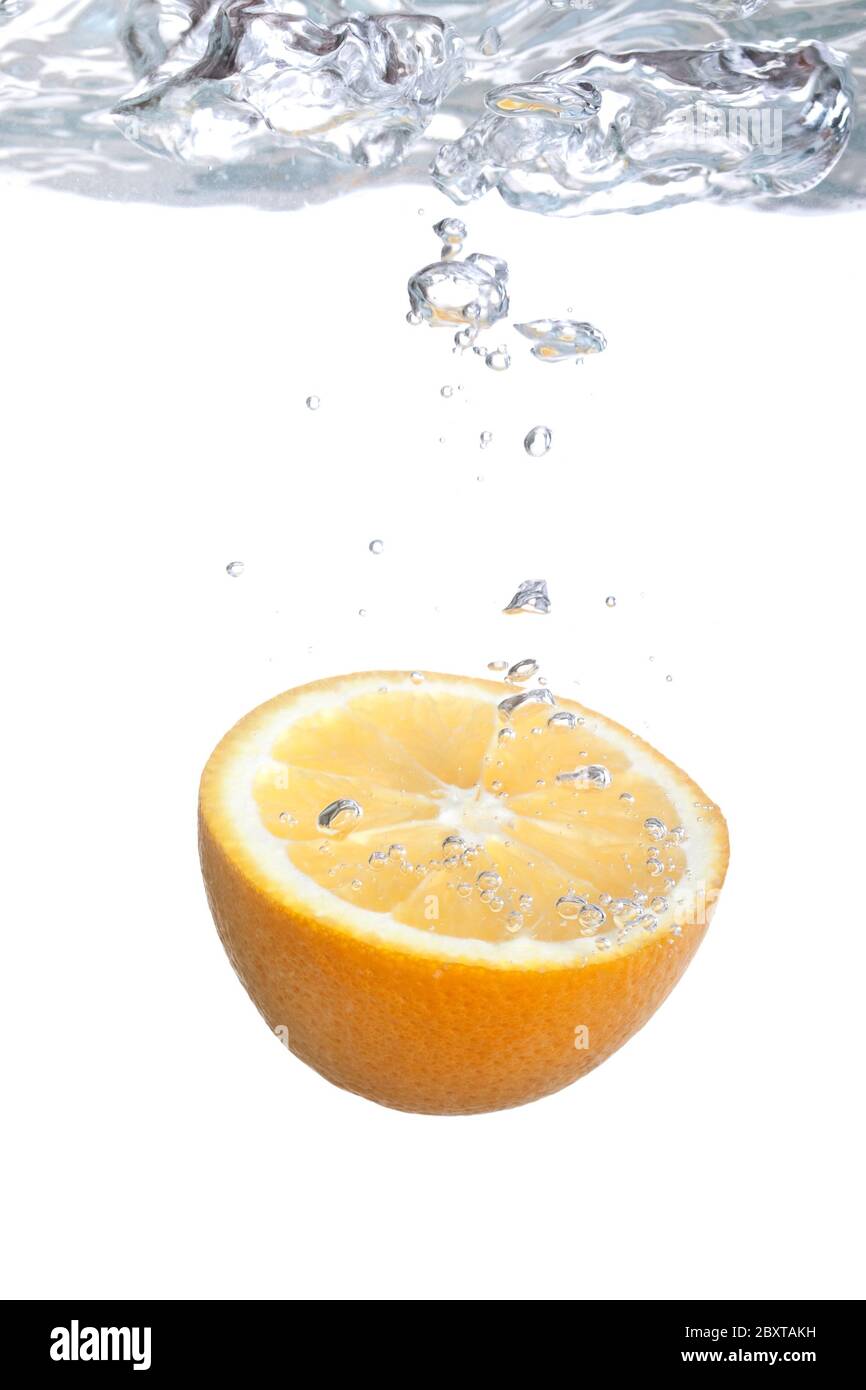 Orange falls into water Stock Photo - Alamy