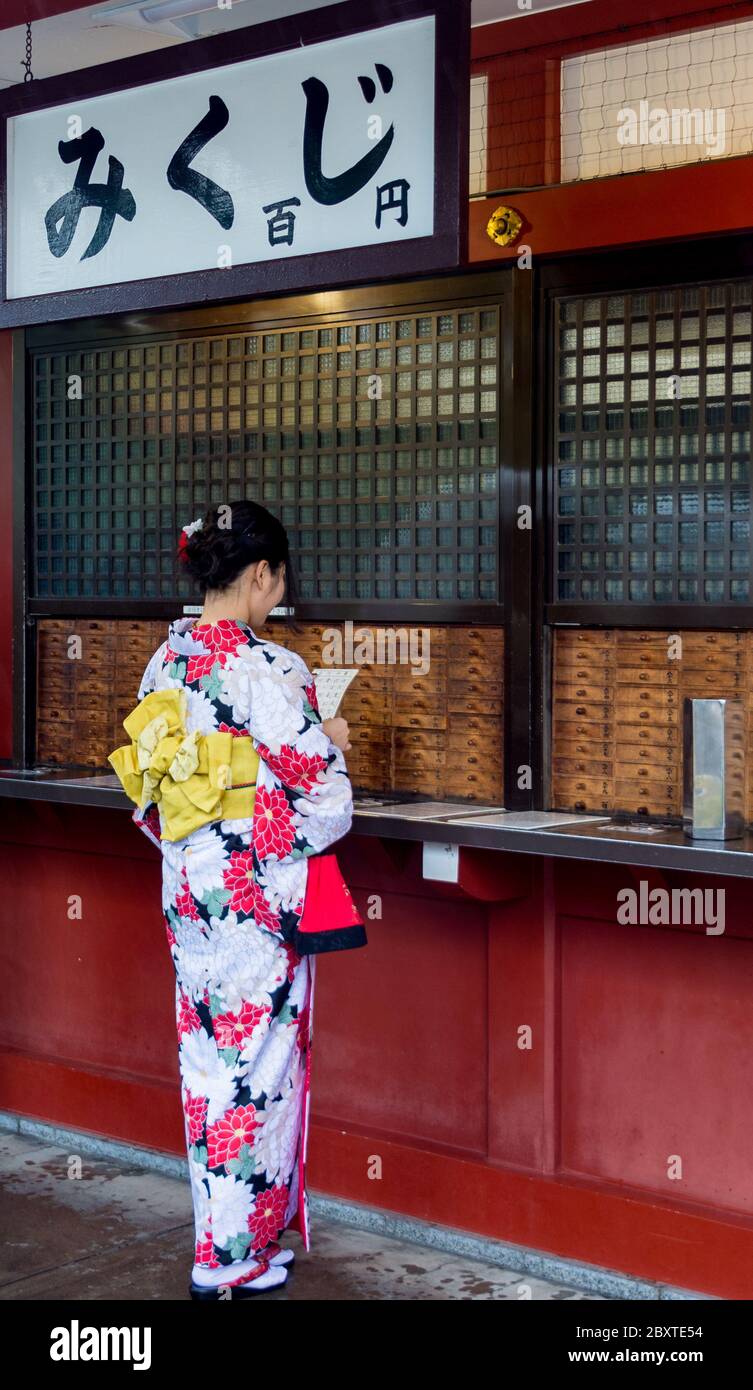 Tokyo / Japan - October 19, 2017: Ancient Senso-ji Buddhist temple in Tokyo. Girl in kimono is ...
