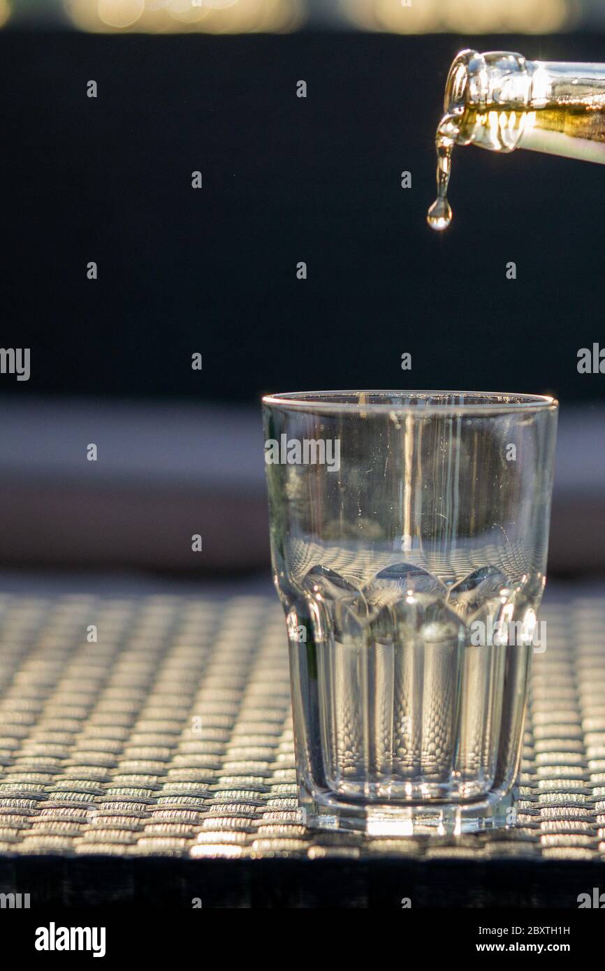 Beer drop falling down to the glass. Freezing motion. Bar, pub ...
