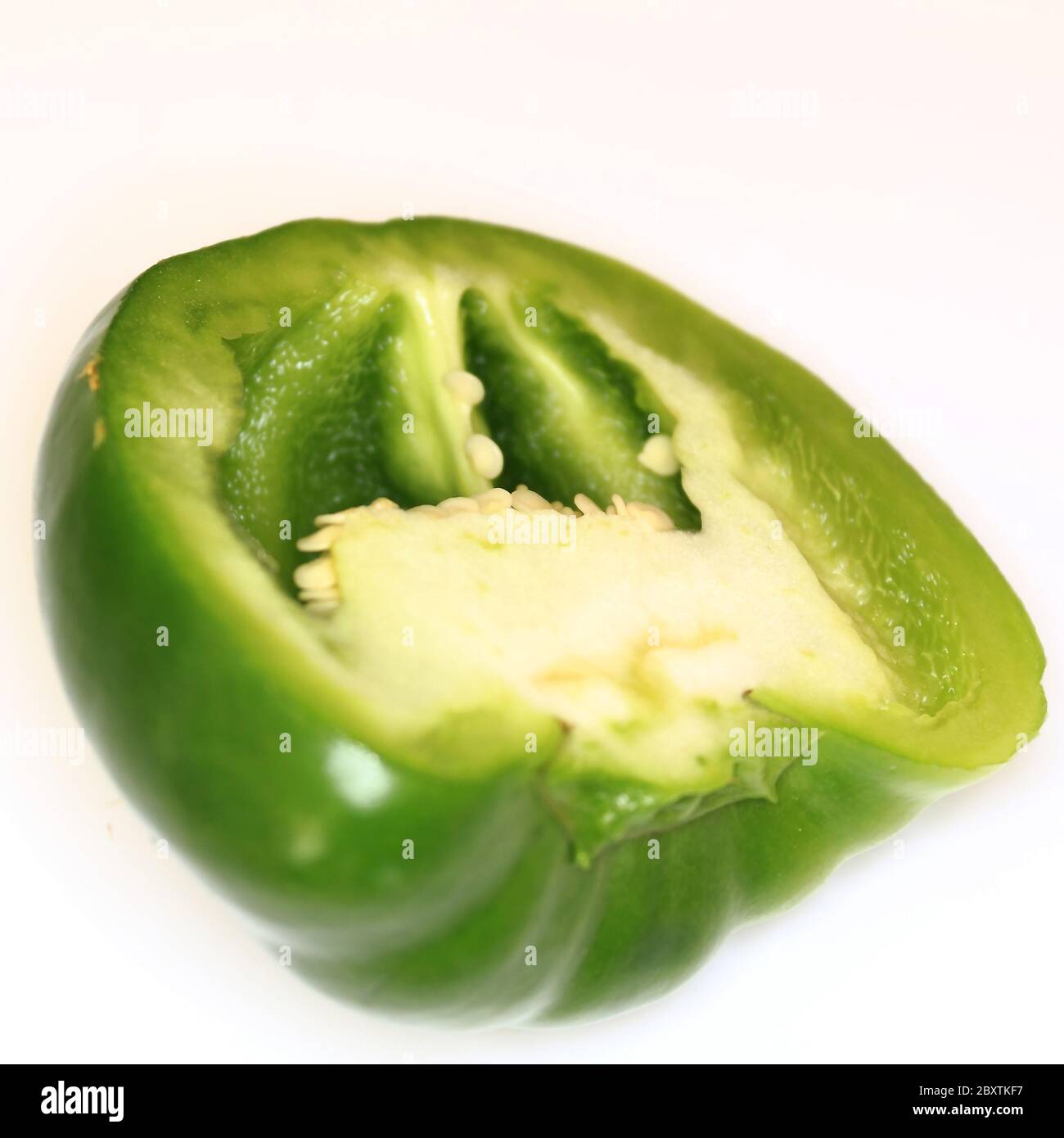 Pepper half on a white background Stock Photo - Alamy
