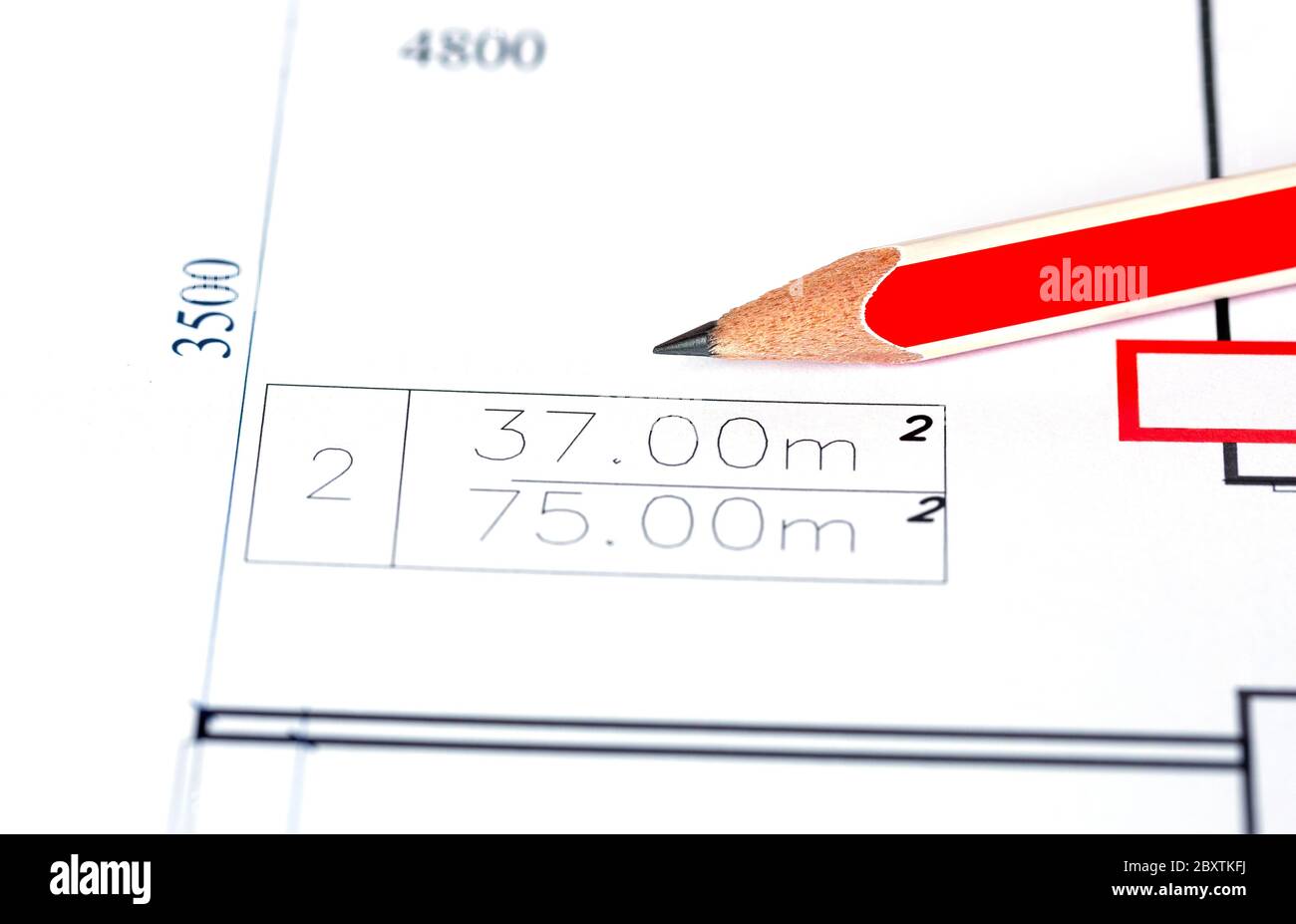 Macro close up of quantity surveyors hand reviewing technical drawing ...