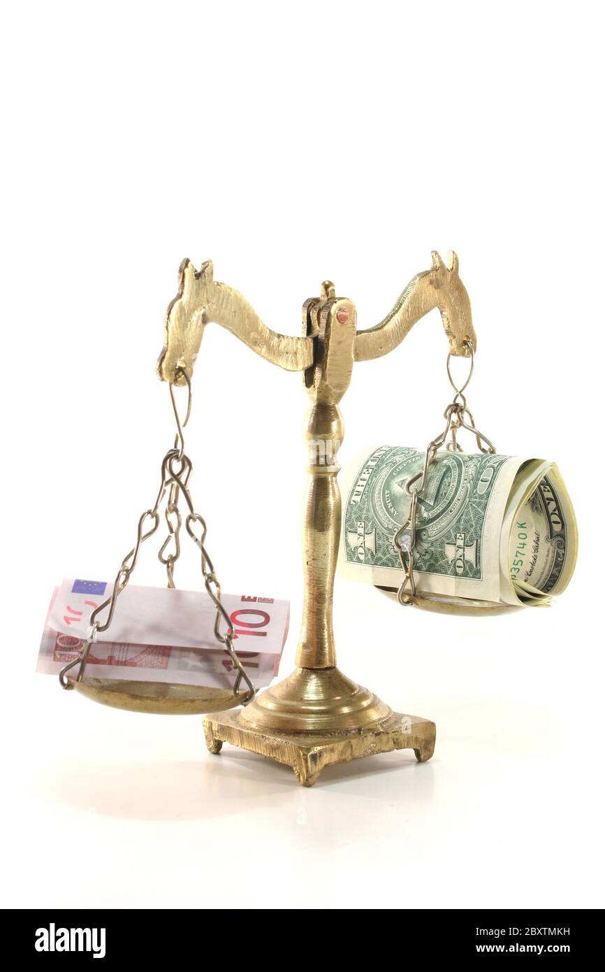 Scales with money Stock Photo - Alamy